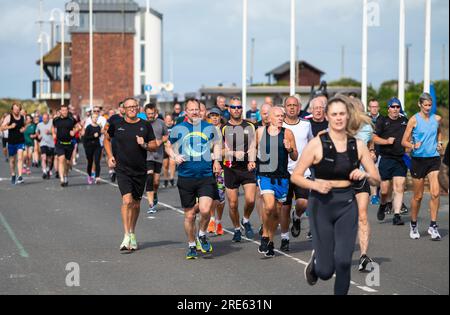 Runners at the weekly Parkrun (Park Run), a community event, running ...