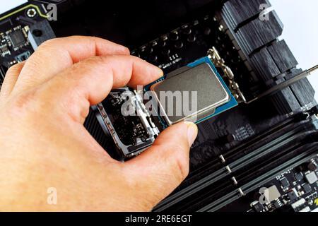 Hand of computer engineering plugging computer cpu processor memory change components into ...