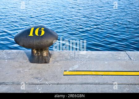 Number 16, sixteen, stencil yellow digit painted on a big commercial ...