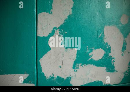 Repairing wall. White spots on green. Wall alignment. Paint application ...