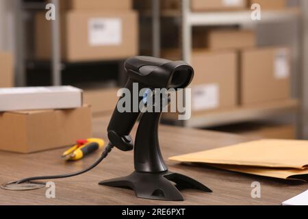 Black modern barcode scanner on wooden table in office. Online store ...