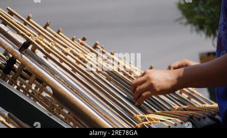 Man playing the Angklung instrument from Indonesia Stock Photo - Alamy