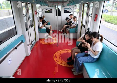 Two autonomous rail buses travel on the road in Chengdu City, southwest ...