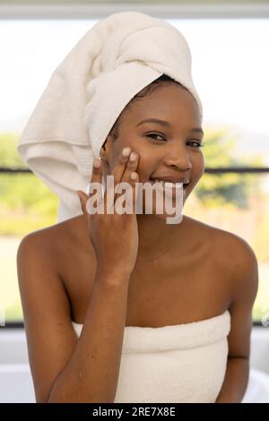 cosmetic for hair care, cream and towel on a colored background top ...