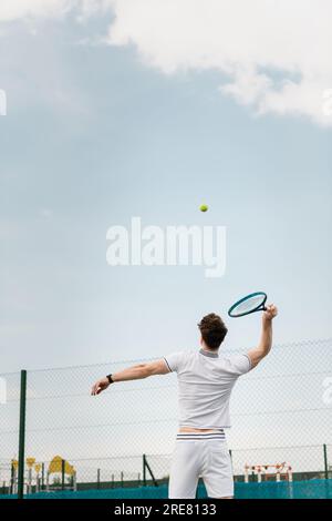 Man hitting a tennis ball back Stock Photo - Alamy