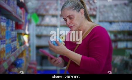 Female Shopper Cross-Checking Product Details Online Using Smartphone ...