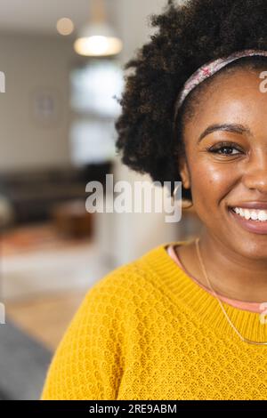 African american woman wearing a sweater shouting and screaming loud to ...