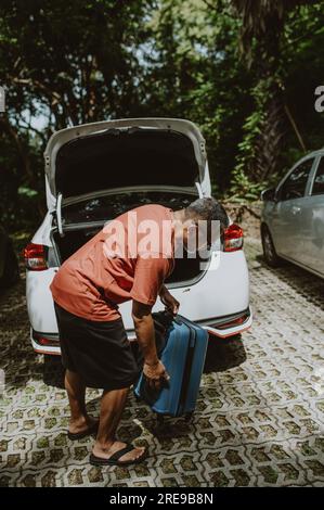 Man pushing trolley luggage bag outdoor Stock Photo - Alamy