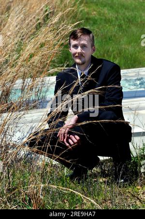 Caucasian man with mustache wearing business clothes pointing to the ...