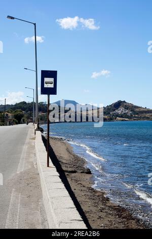 Greek sign for a bus stop alongside coast road from Petra village Stock ...