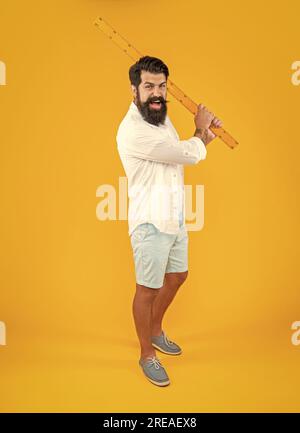 aggressive man with measuring ruler in studio. man with measuring ruler ...