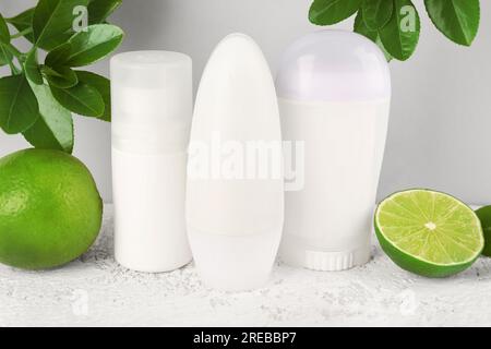 Deodorant and lime on light table Stock Photo - Alamy