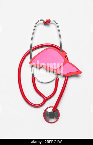 Pink paper liver with stethoscope on white background Stock Photo - Alamy