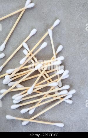 Natural wood and cotton ear buds on mottled gray background Stock Photo ...