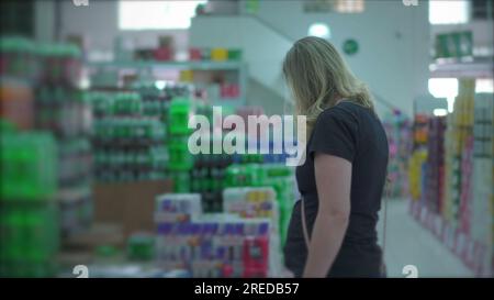 Woman Inspecting Items in Supermarket s Soda Drink Section Stock Photo ...