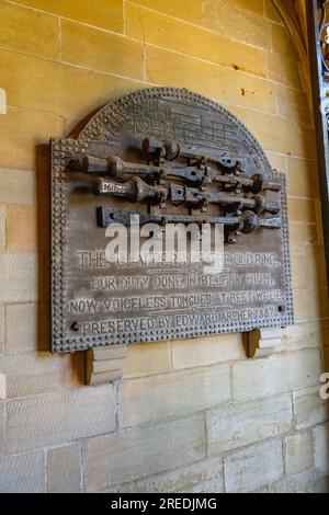 The old bell clappers mounted on the wall of Malvern priory church ...