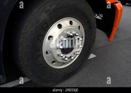 The front wheels of a 2004 Mack semi truck on display at a car show in ...