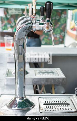 Beer taps at an outdoor stand Stock Photo - Alamy