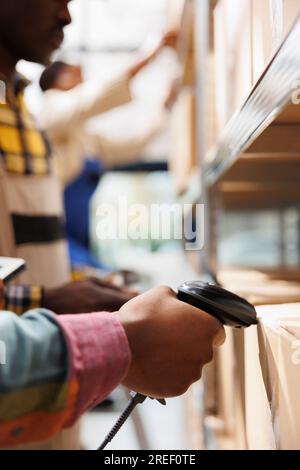 African american storehouse employee arm using barcode scanner on ...