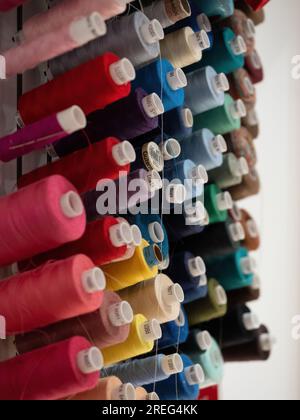 Set of thread spools on blue background Stock Photo - Alamy