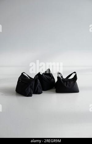 Three sand bags on a studio cyclorama with a stand, c-stand ...
