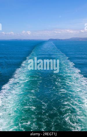 The wake from a ferry crossing the Irish sea on a clear, clam day Stock ...