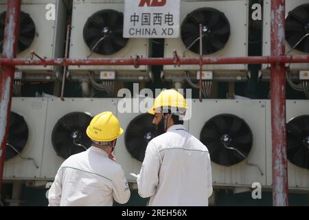 Lahore, Pakistan. 4th July, 2023. Zubair Tufail (R) works in the ...