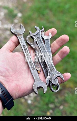 Metal shiny horn keys in the hand of the master Stock Photo - Alamy