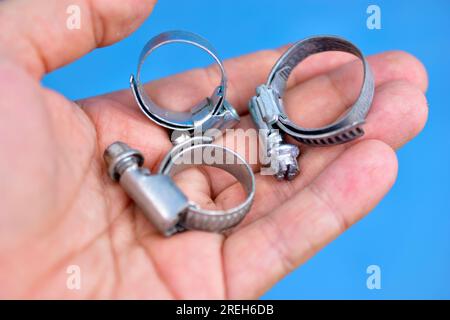 Iron clamps with thread in the hands of the master Stock Photo - Alamy