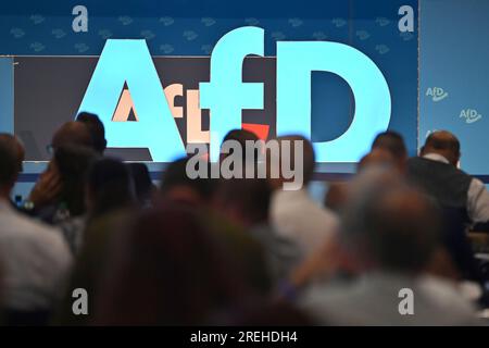 Marginal view of the blue AfD logo, with the delegates sitting in the ...
