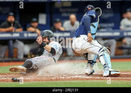 Miami Marlins' Jon Berti slides behind Tampa Bay Rays catcher Christian ...