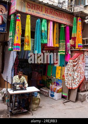 Indian boy using a sewing machine on the Sangastrashan street, New ...