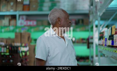 Elderly African American Man Selecting Alcoholic Beverages at ...