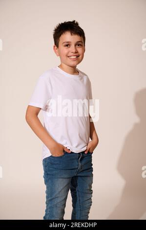 Handsome boy, teenager smiling a toothy smile, showing to camera a ...