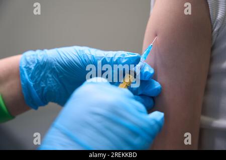Patient in the clinic receives a preventive vaccination in arm Stock ...