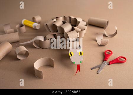 a snake made out of toilet paper rolls, craft made of recycle cardboard ...