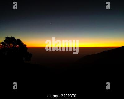 Exotic 180-degree shot of orange winter line with mountain silhouettes ...