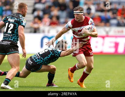 Wigan Warriors' Jake Wardle (centre) is tackled by Catalans Dragons ...