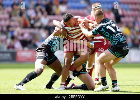 Wigan Warriors' Patrick Mago (centre) lifts the trophy with team-mates ...