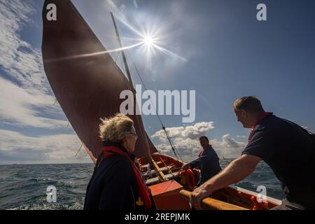 A traditional Coble fishing boat is sailed off the coast of Bridlington ...