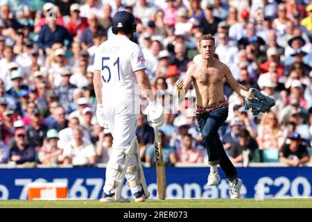 A pitch invader runs on the field during the Indian Premier League ...