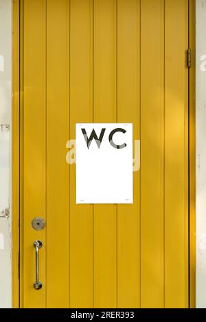The sign a toilet on a yellow background. Copyspace. abbreviation WC ...