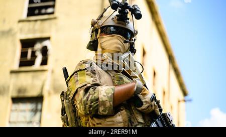 Expert team of soldiers with weapons attacking enemy during military ...