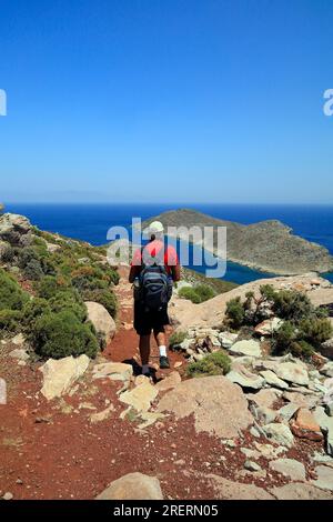 Walker on the path from Livadia to Lethra beach along the rocky ...