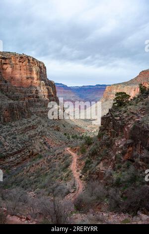 Rugged canyon landscape with a winding trail and clear blue sky. USA ...