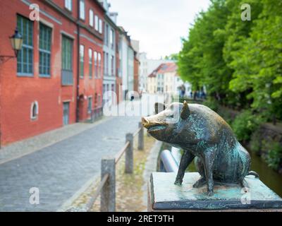 Pig as a bronze statue on the canal bridge in the city of Wismar Stock ...
