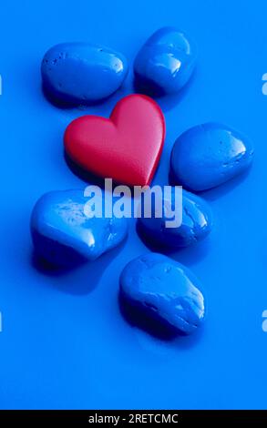 Red heart and blue stones Stock Photo - Alamy