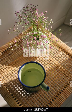 Flowers in an iron mug on the wooden background. Toned image Stock ...