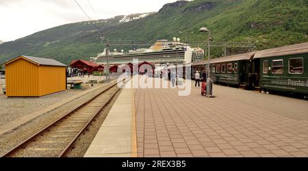 Passengers waiting to board the Flamsbana train at Flam station, Norway ...