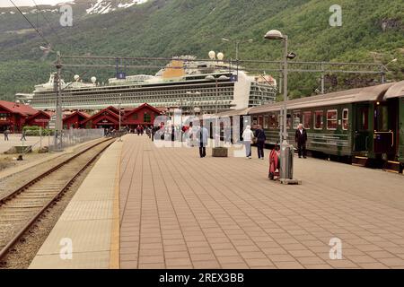 Passengers waiting to board the Flamsbana train at Flam station, Norway ...